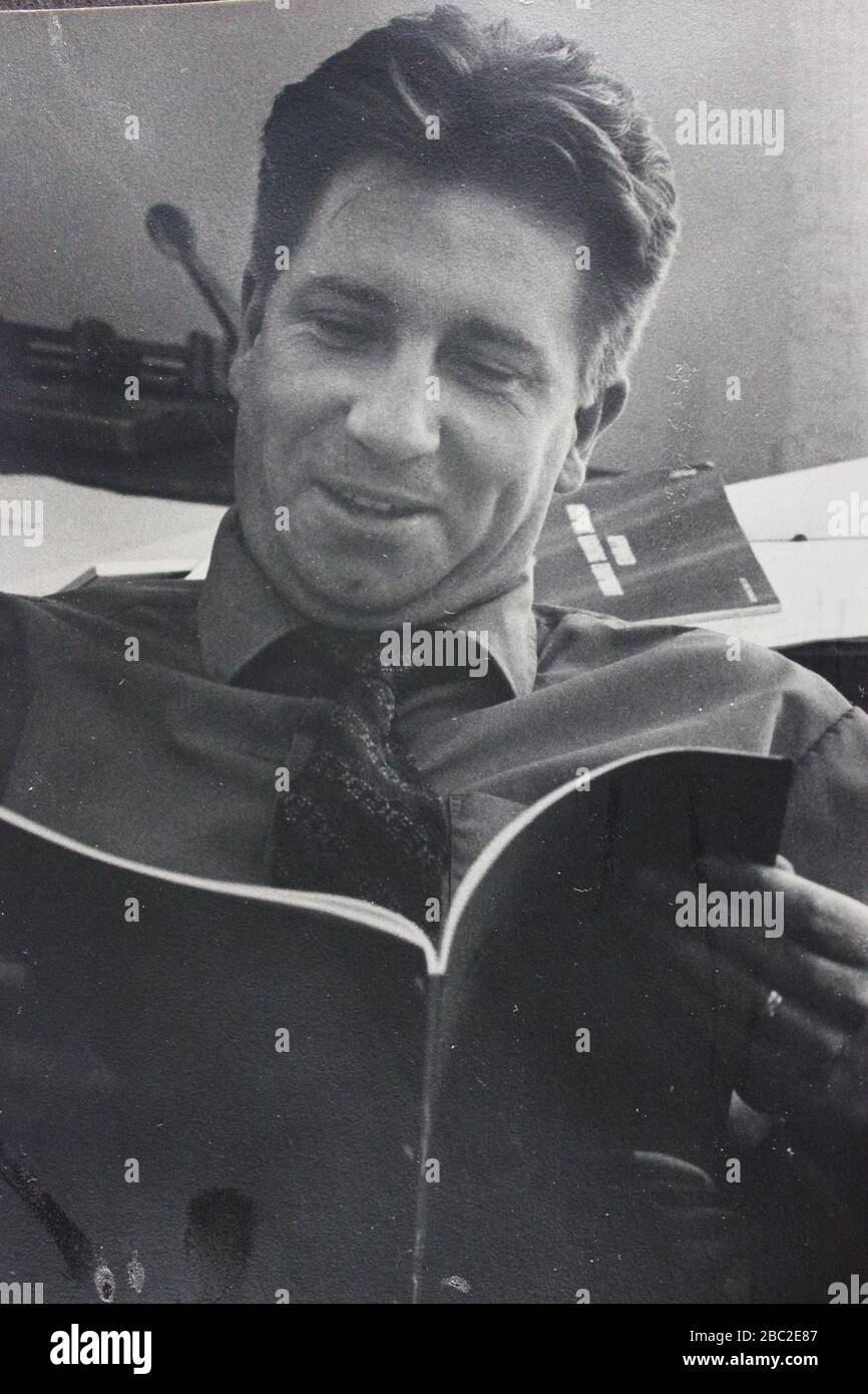 A very happy man reading a journal magazine Stock Photo - Alamy