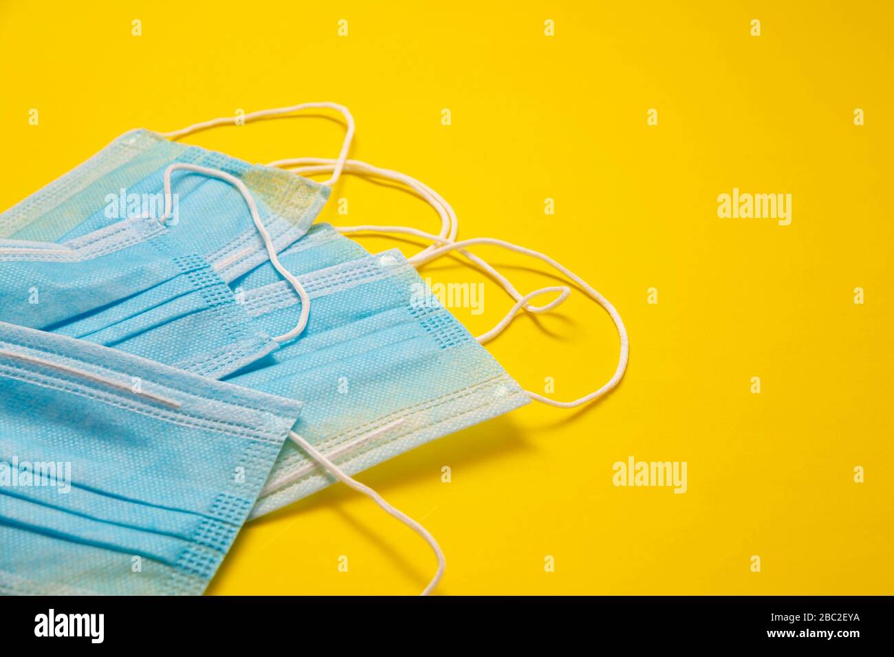 disposable blue medical face masks to prevent infection on yellow ...
