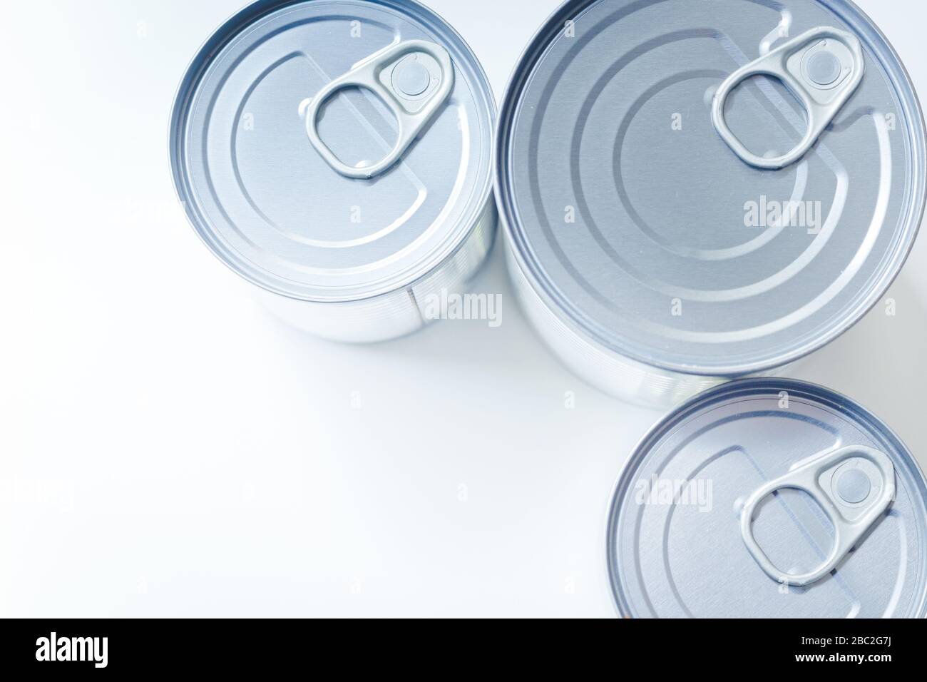 Top view of silver tin cans closed on white background Stock Photo - Alamy
