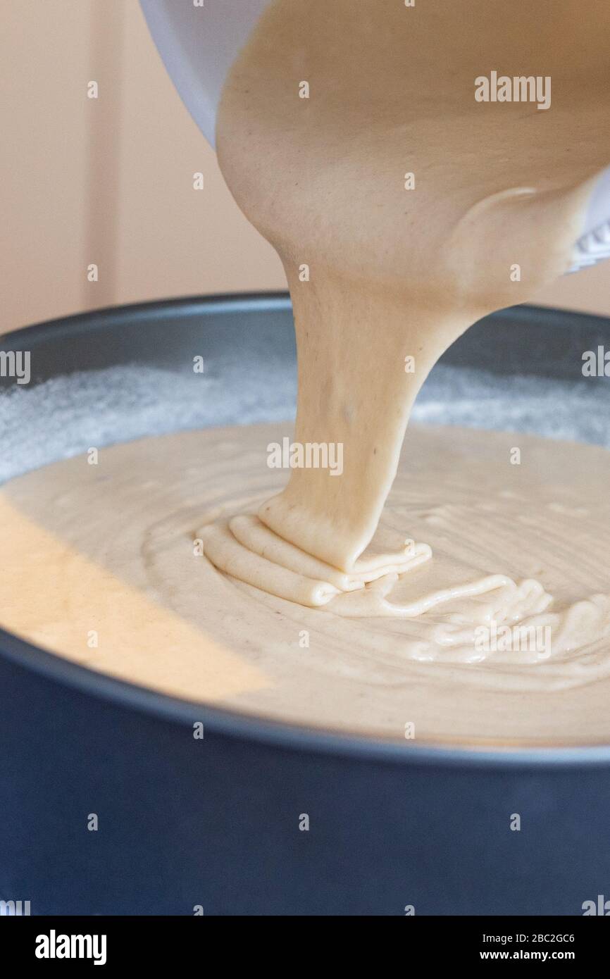 Pour batter into prepared pan. Cake mixture Stock Photo - Alamy