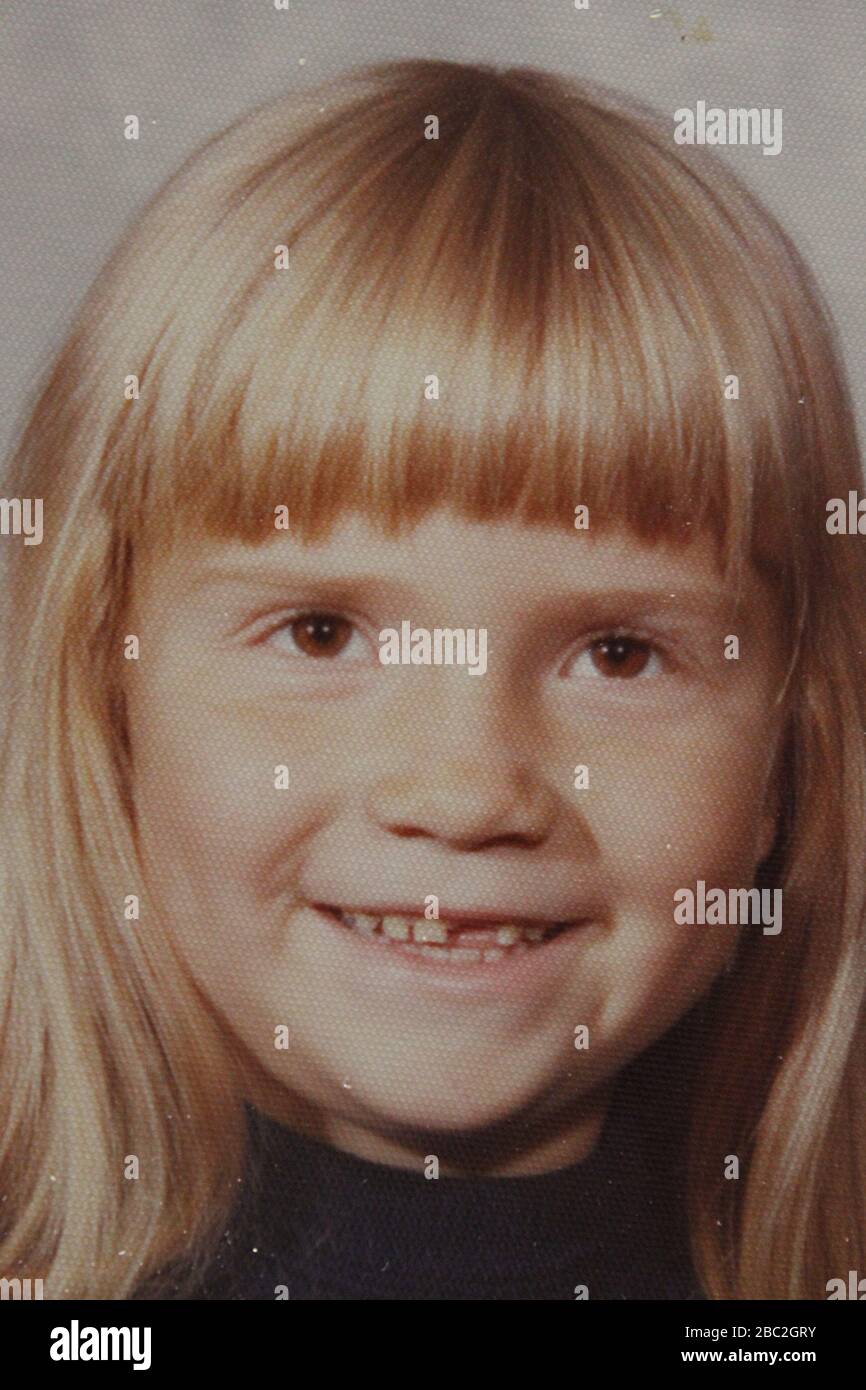 Formal grade school portrait of a beautiful young caucasian girl with ...