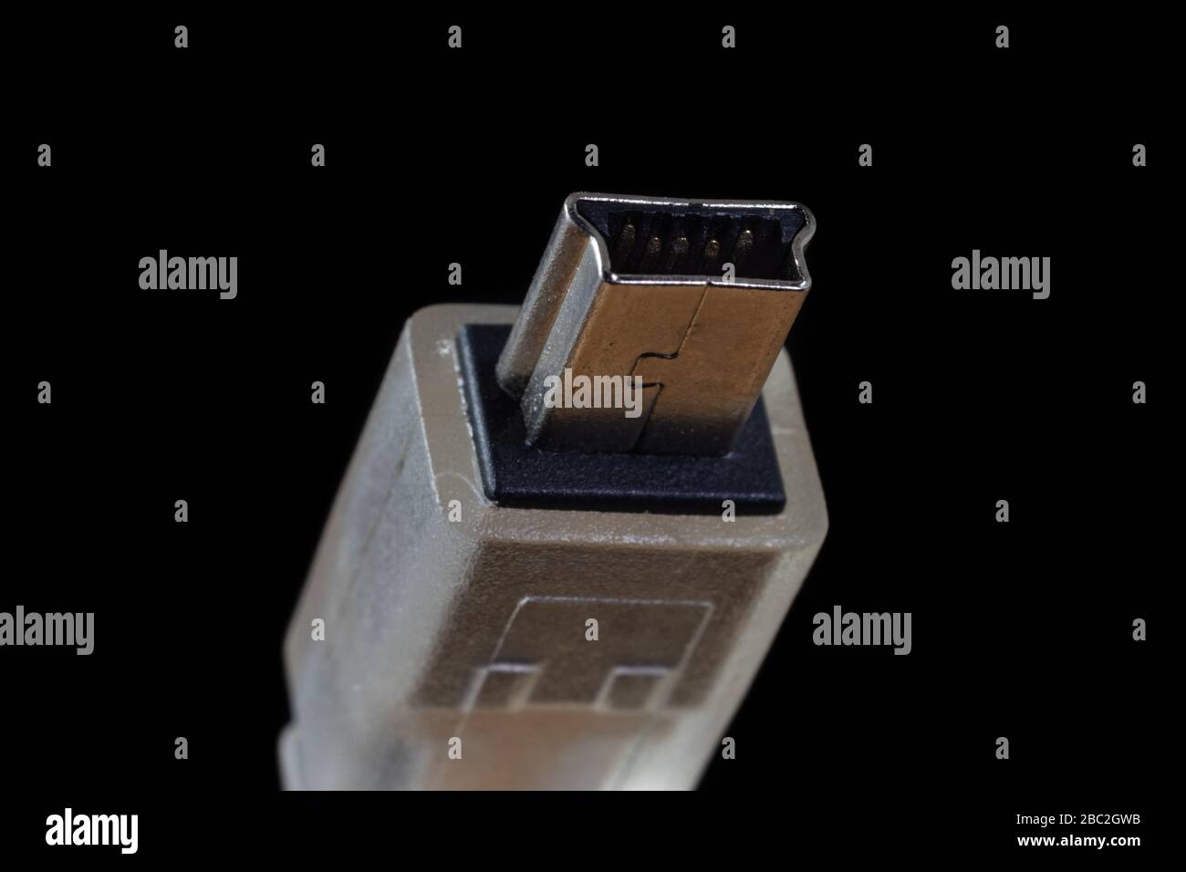 USB mini B plug isolated on a black background. Common 5 pin digital ...