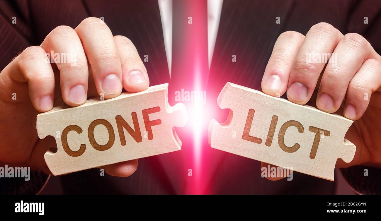 Man breaks puzzles with word Conflict. Dispute solution , compromise ...