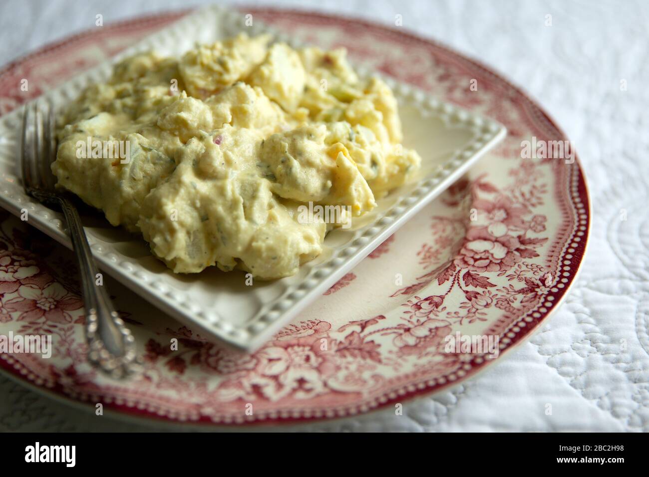 Southern style potato salad on antique plates Stock Photo - Alamy