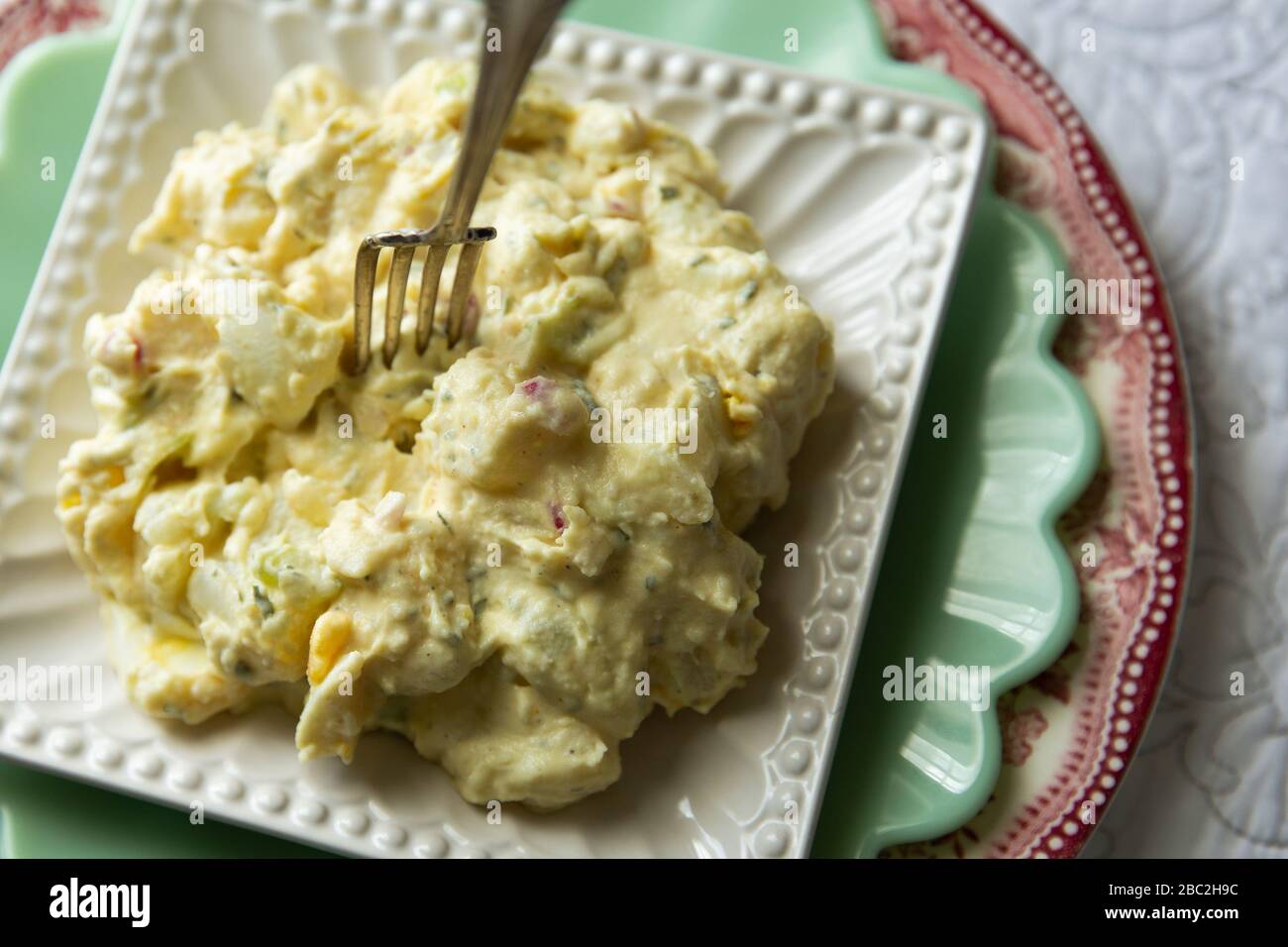 Southern style potato salad on antique plates Stock Photo - Alamy