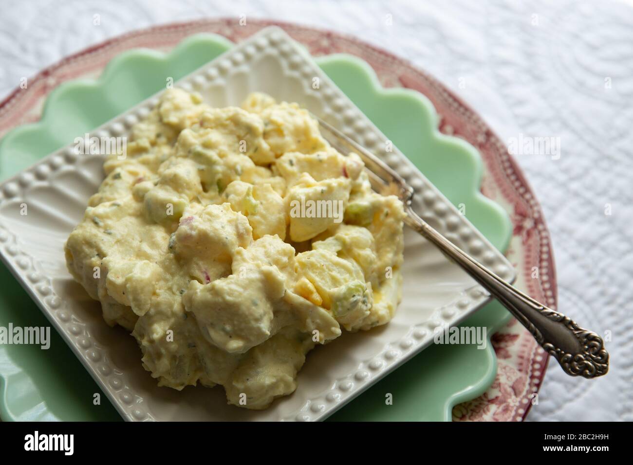 Southern style potato salad on antique plates Stock Photo - Alamy