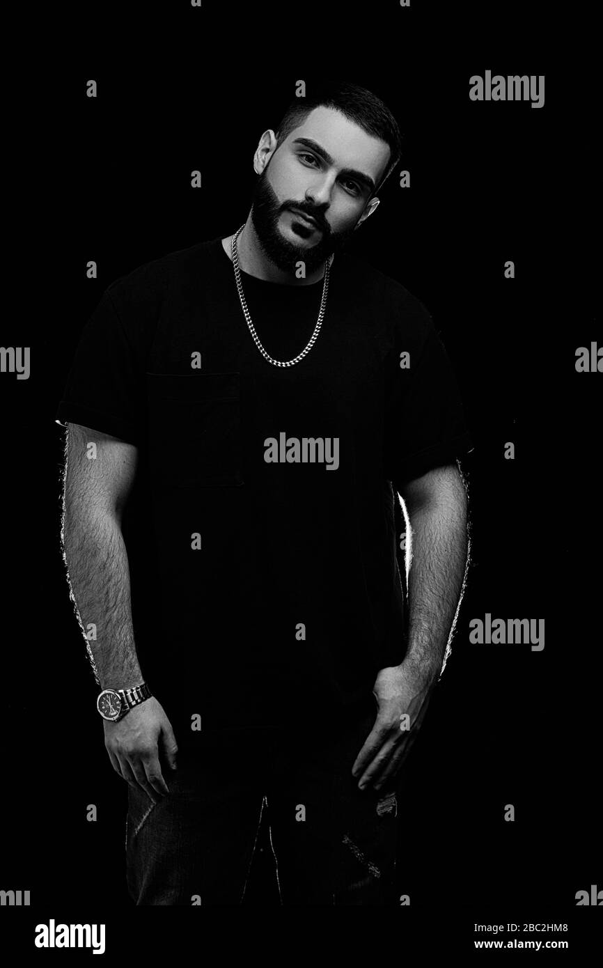 close-up of a dramatic portrait of a young serious guy, musician ...