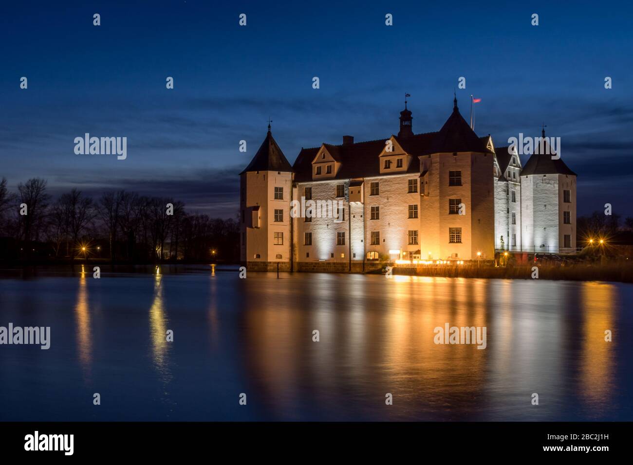 The moated castle in Glücksburg at night Stock Photo - Alamy
