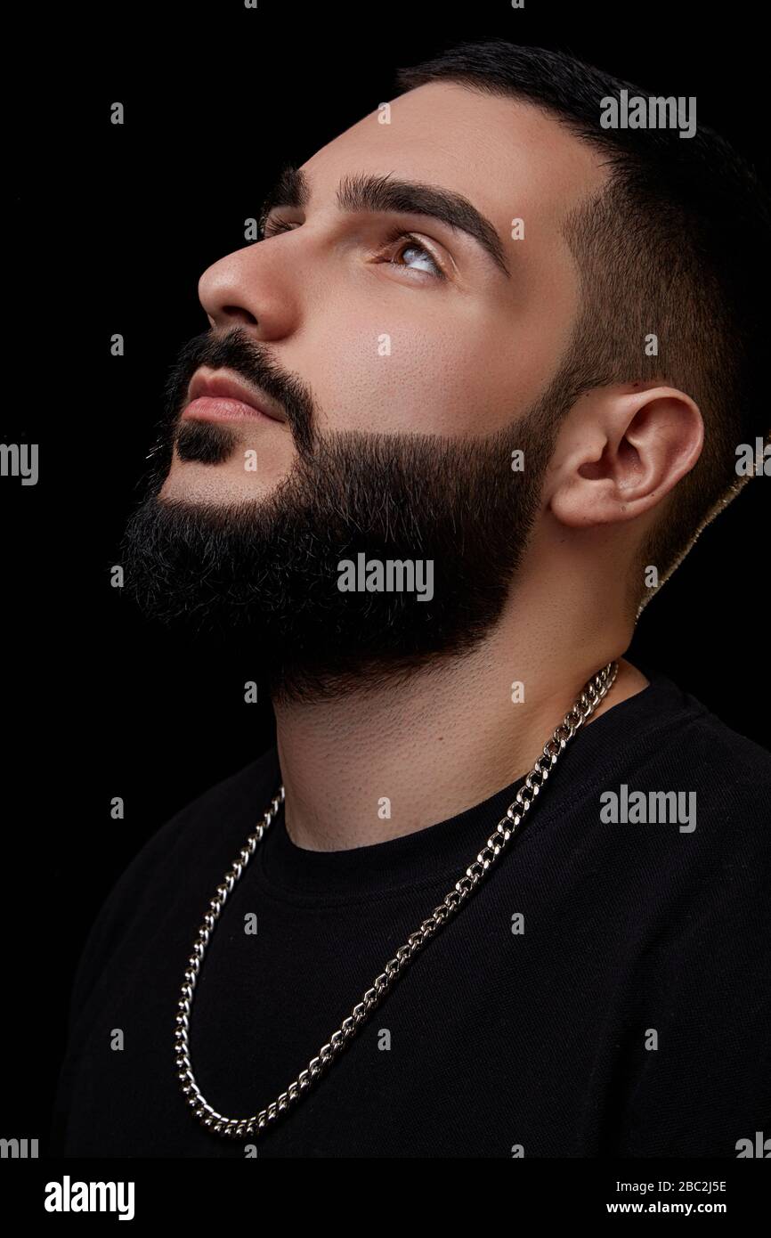 a dramatic portrait of a young serious guy, musician, singer, rapper ...