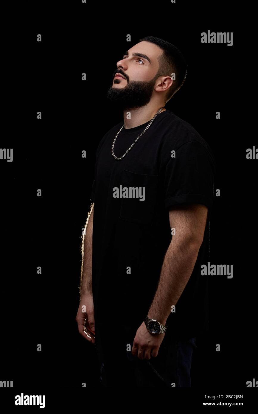 a dramatic portrait of a young serious guy, musician, singer, rapper ...