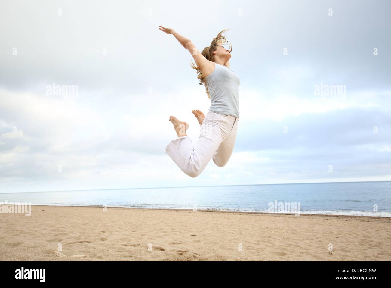 Jumping on the beach hi-res stock photography and images - Alamy