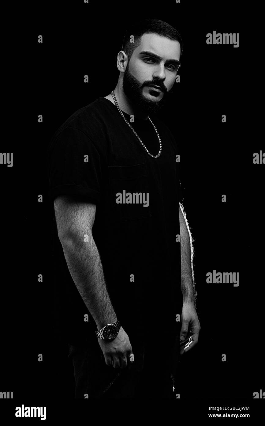 close-up of a dramatic portrait of a young serious guy, musician ...