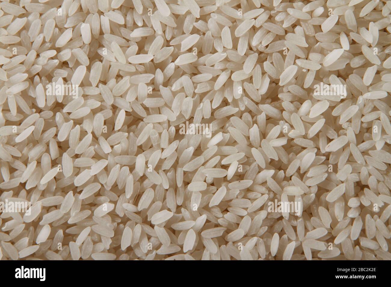 Heap of raw rice Stock Photo - Alamy