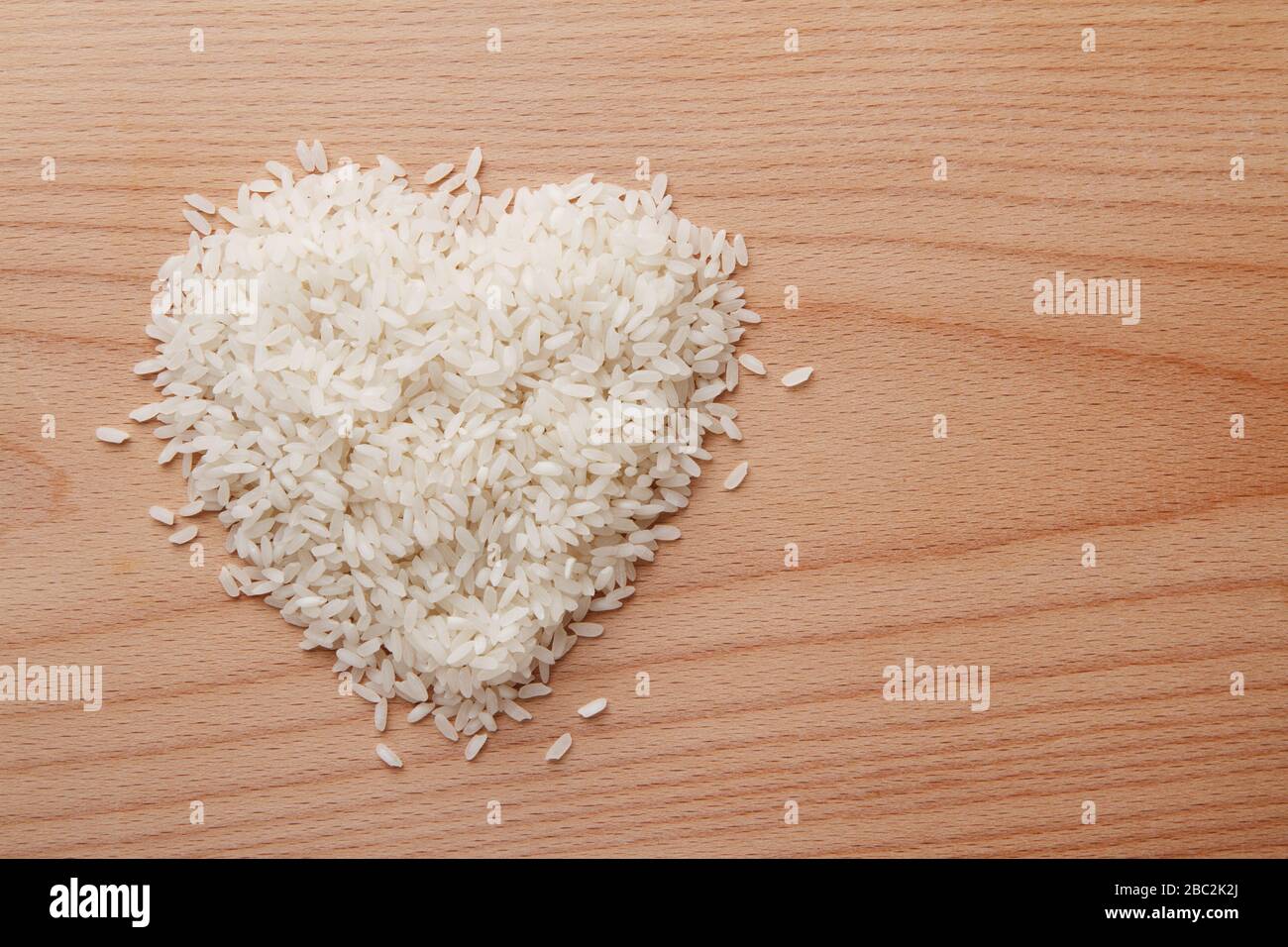 Heap of raw rice heart shape Stock Photo - Alamy