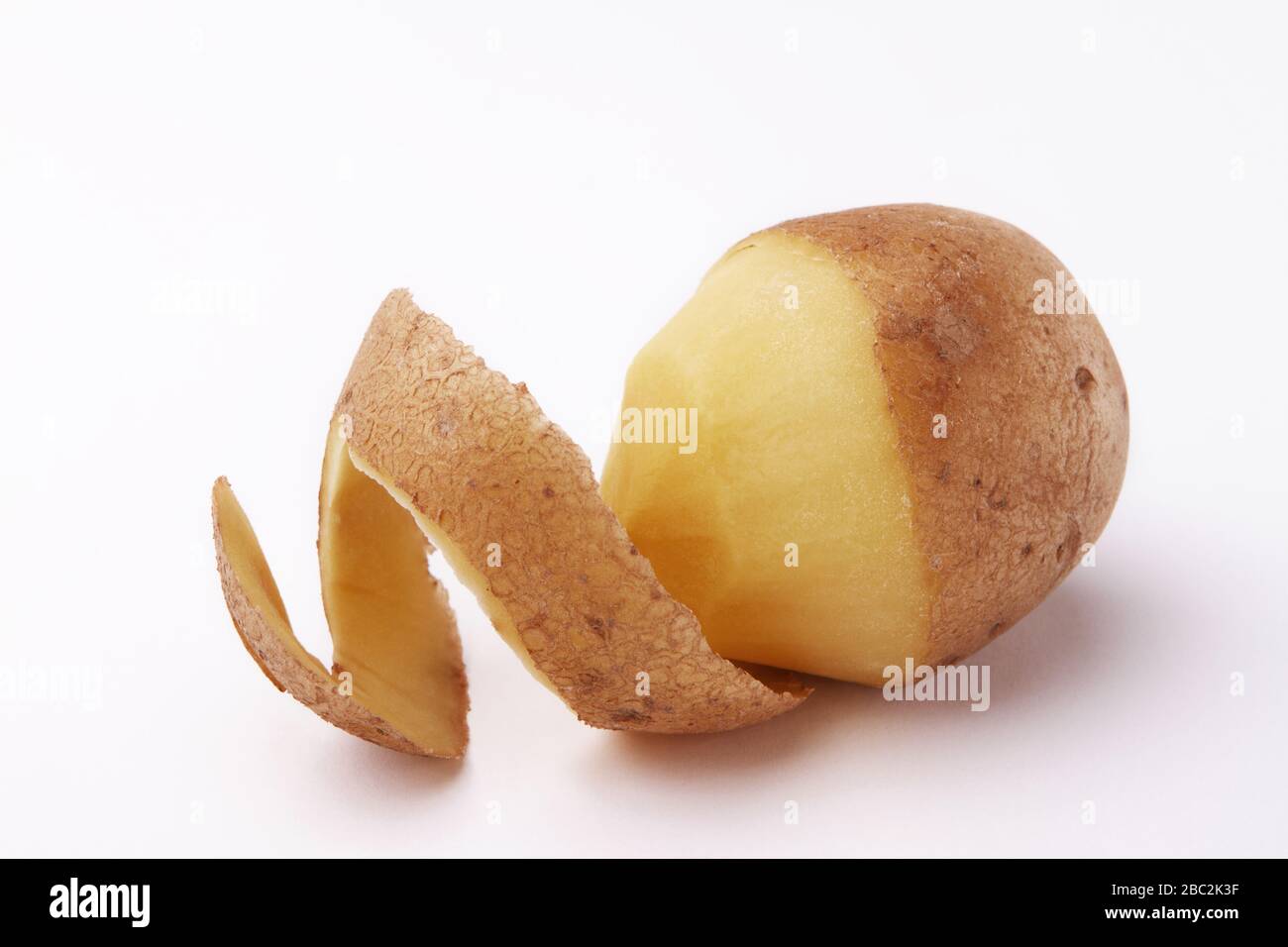 Peeled potato isolated on a white background Stock Photo - Alamy