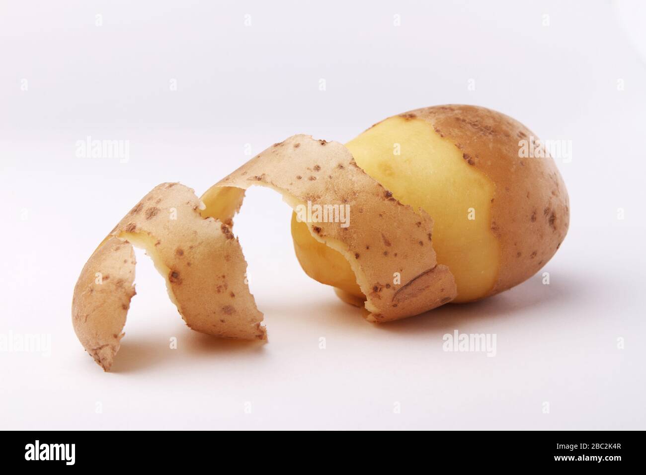 Peeled potato isolated on a white background Stock Photo - Alamy
