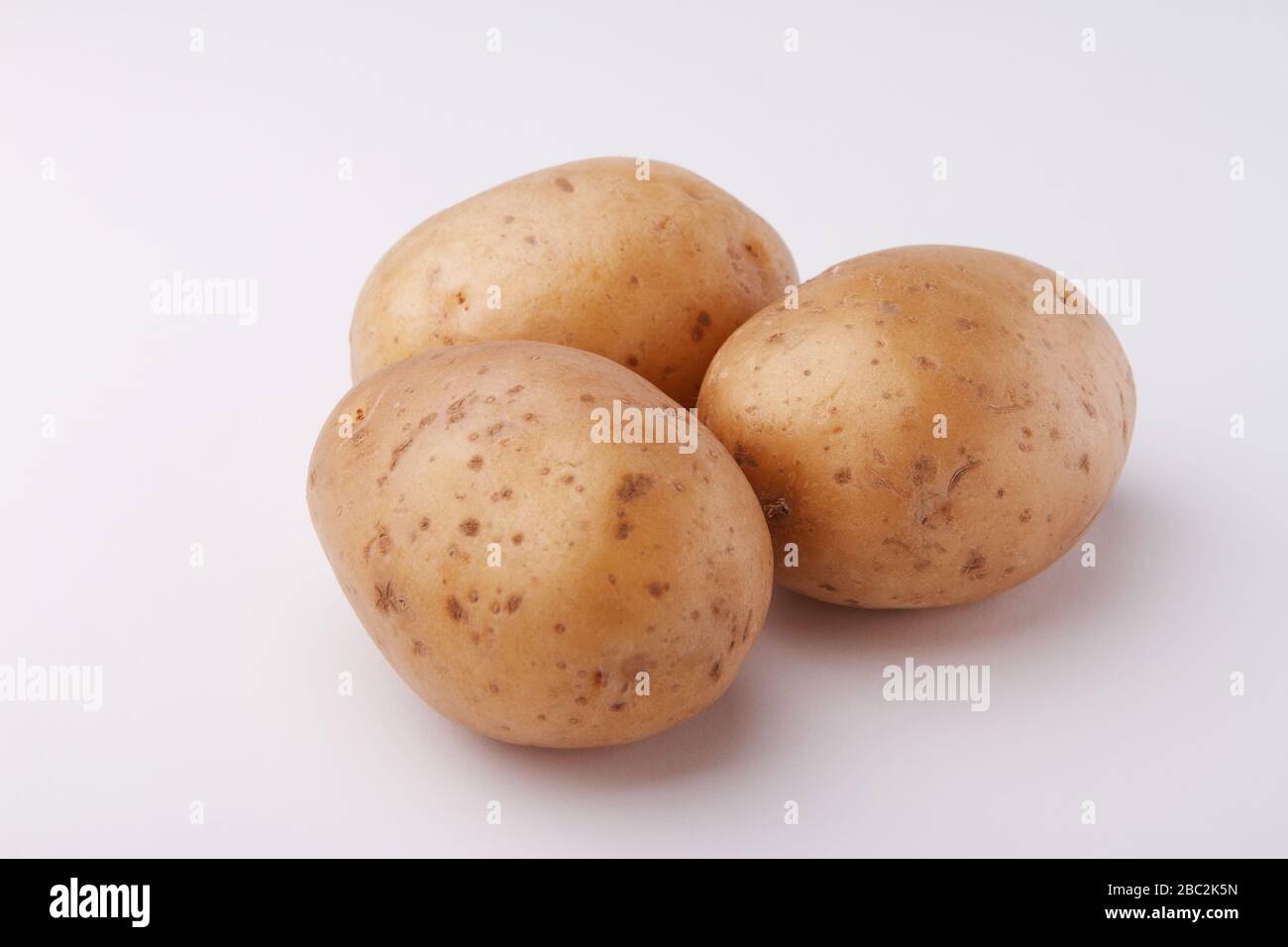 Three potato isolated on white background Stock Photo - Alamy