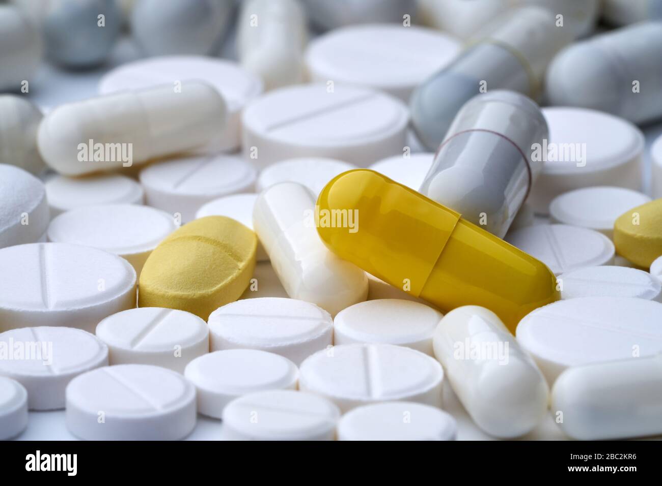 Closeup of multi-colored pills on a white background with texture Stock ...