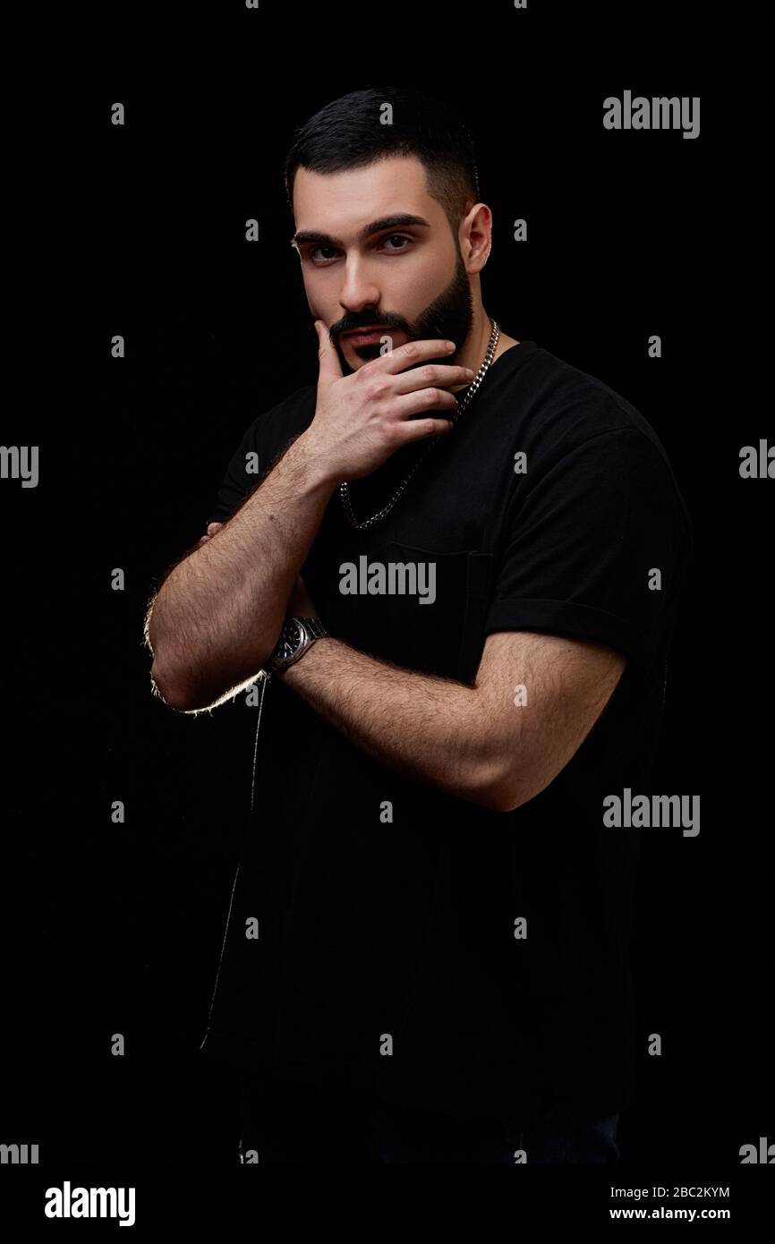 a dramatic portrait of a young serious guy, musician, singer, rapper ...