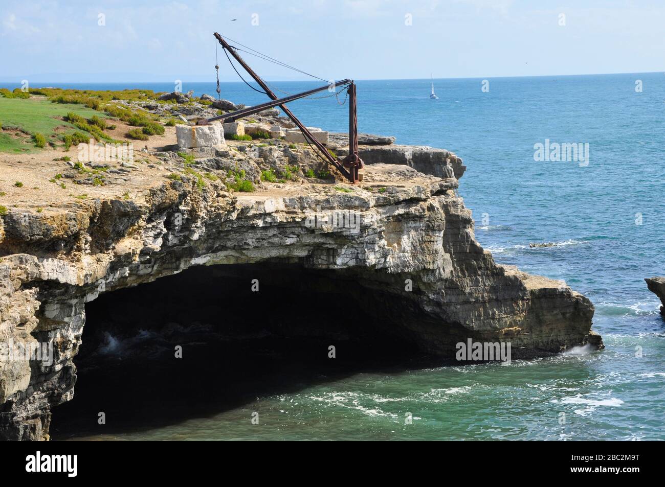 A steel crane on the cliff edge on the Isle of Portland. Originally ...