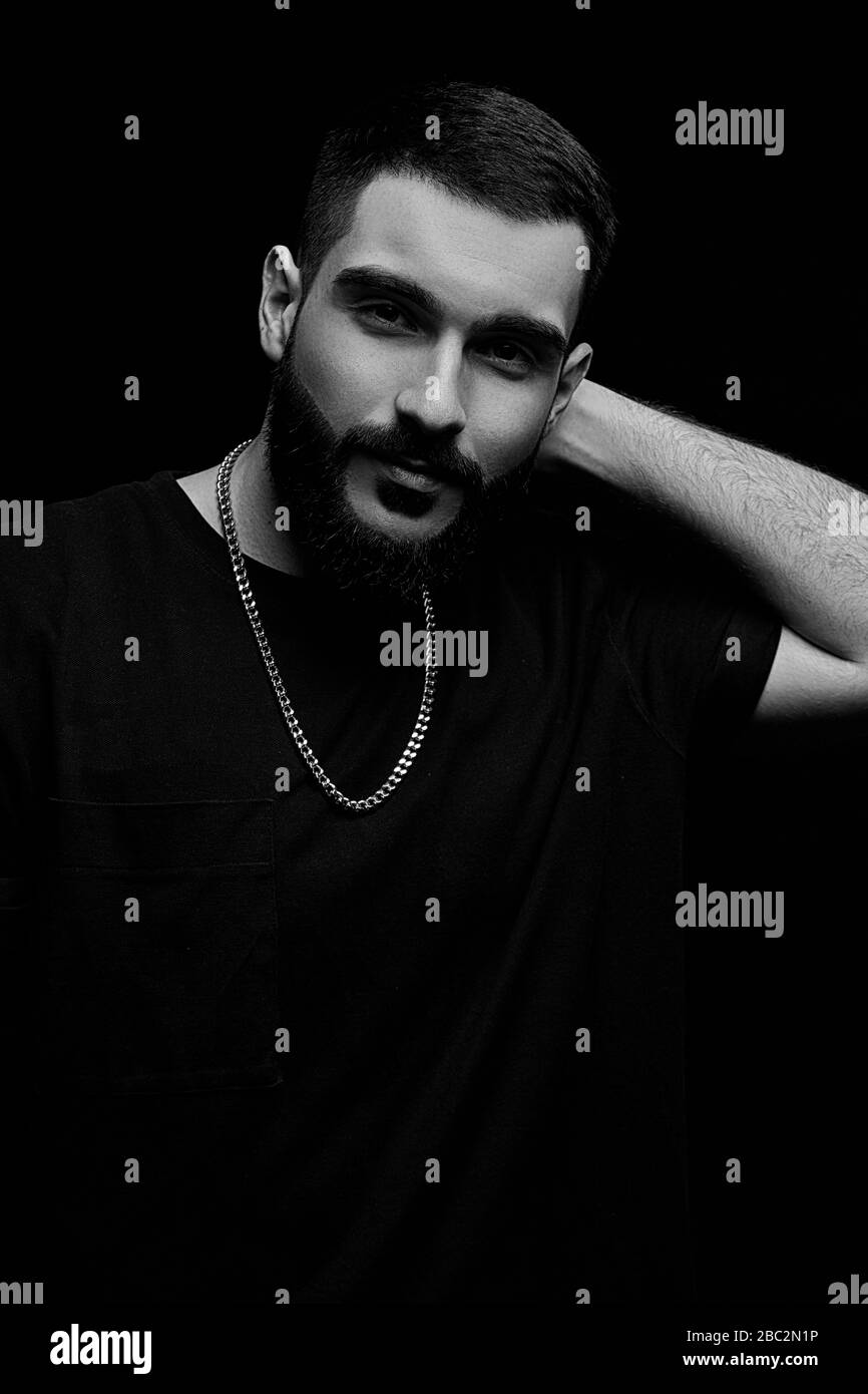 close-up of a dramatic portrait of a young serious guy, musician ...