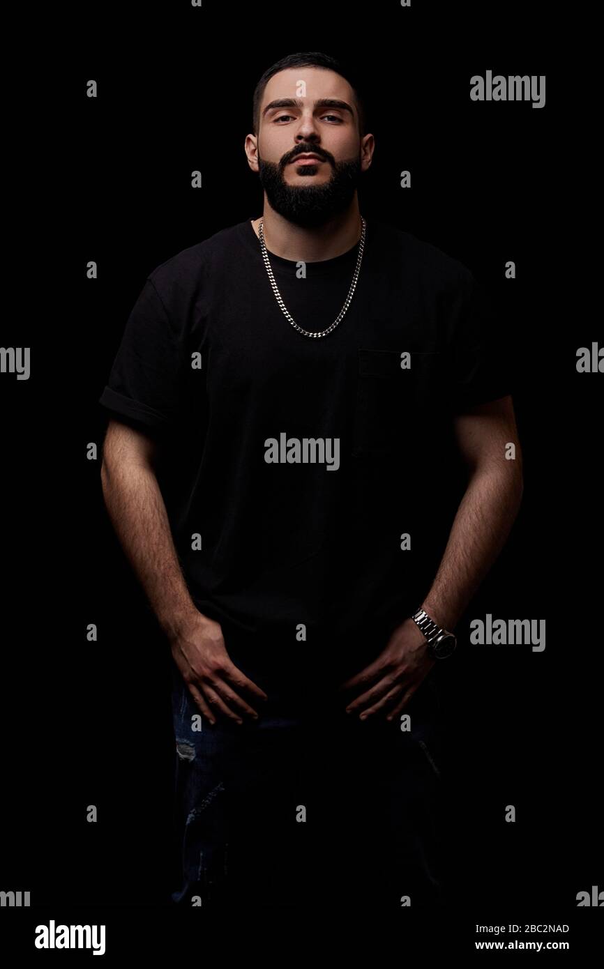 close-up of a dramatic portrait of a young serious guy, musician ...