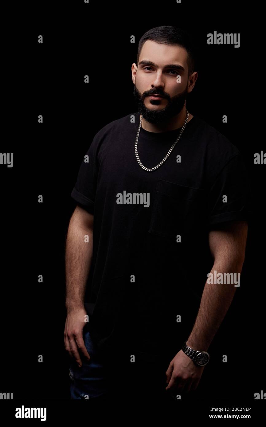 close-up of a dramatic portrait of a young serious guy, musician ...