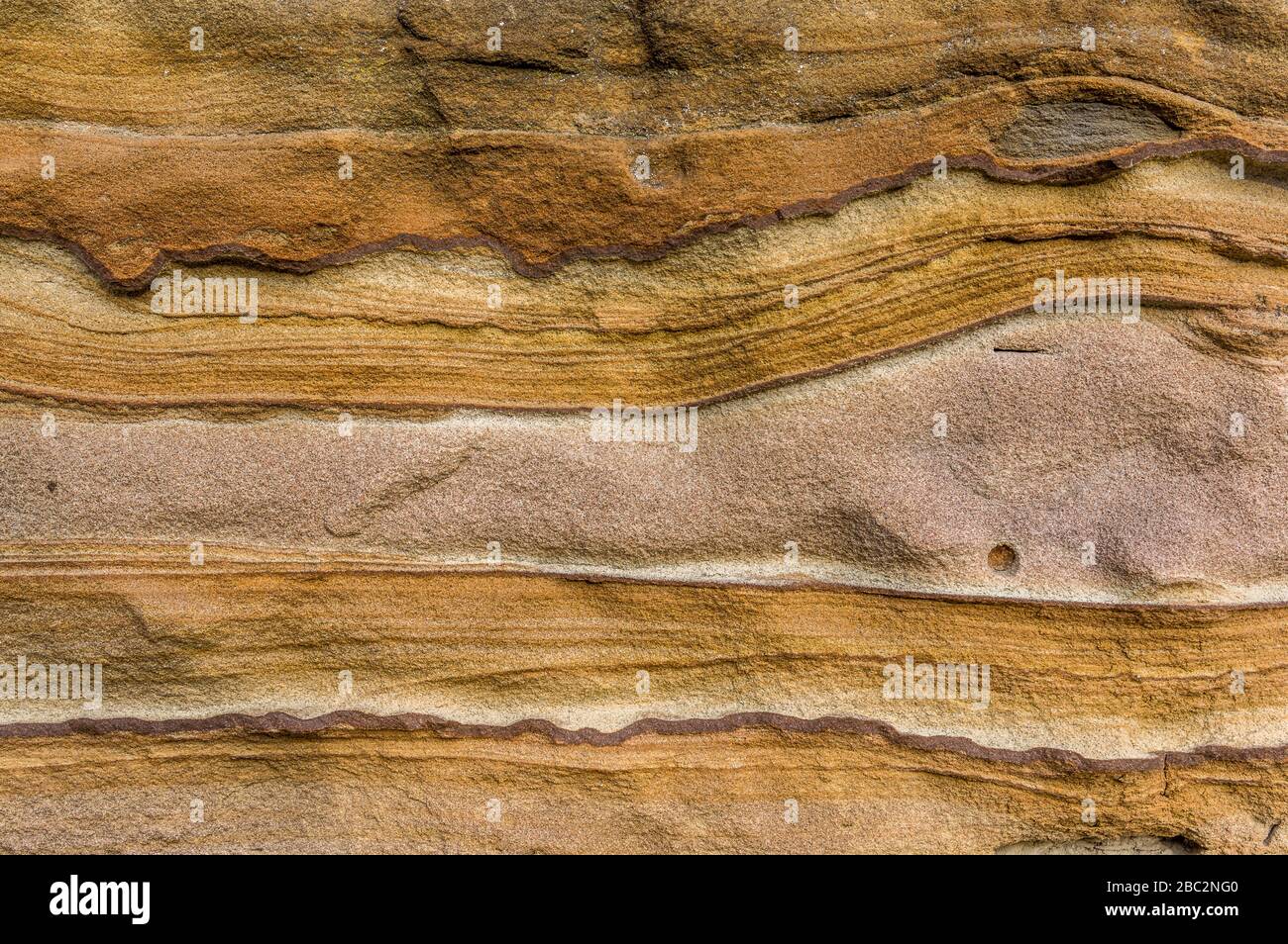 Sandstone wall, sandstone with artistic patterns hatching relief-like ...