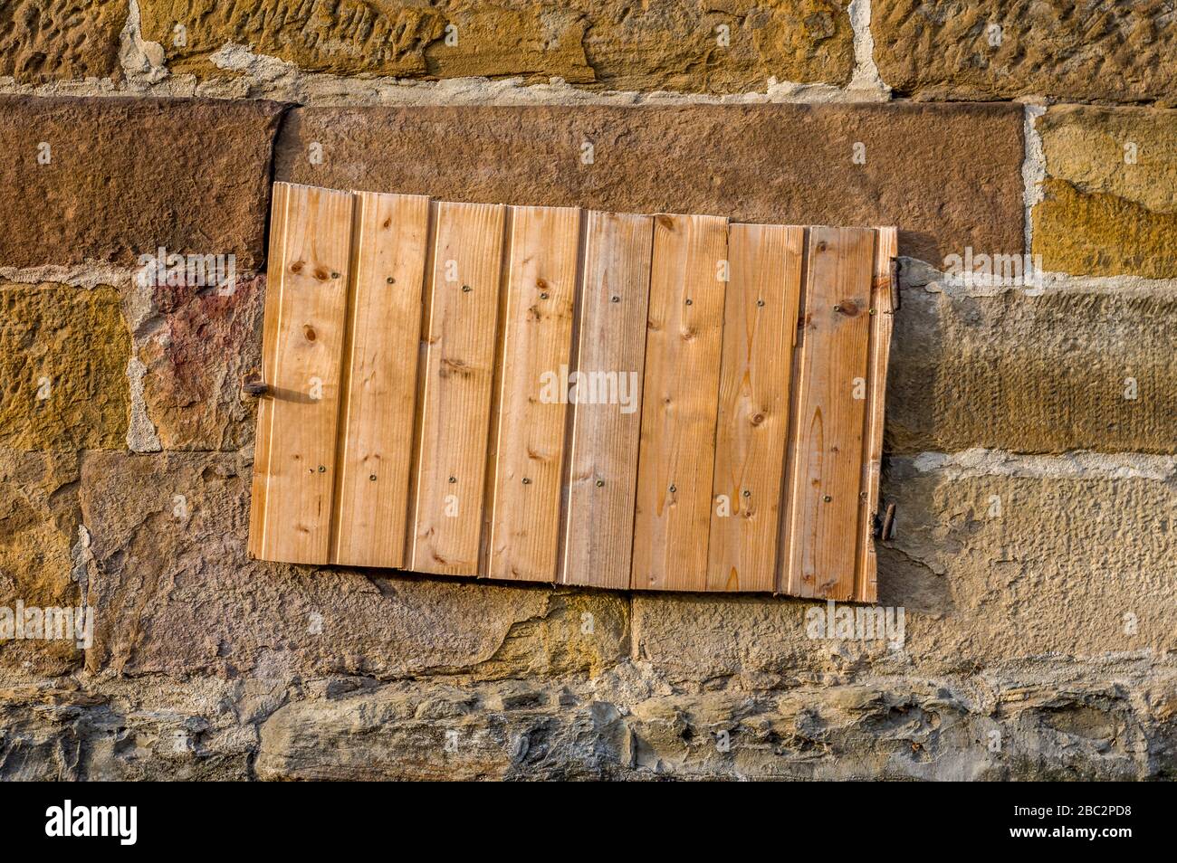 Sandstone wall with basement window and shaft for potato or coal cellar ...