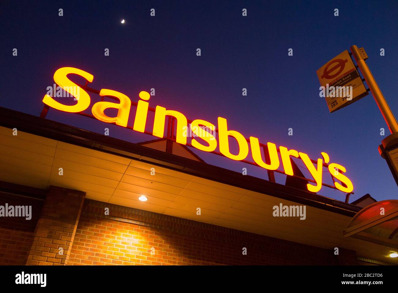 Sainsbury's supermarket shop sign at night / evening with clear blue ...