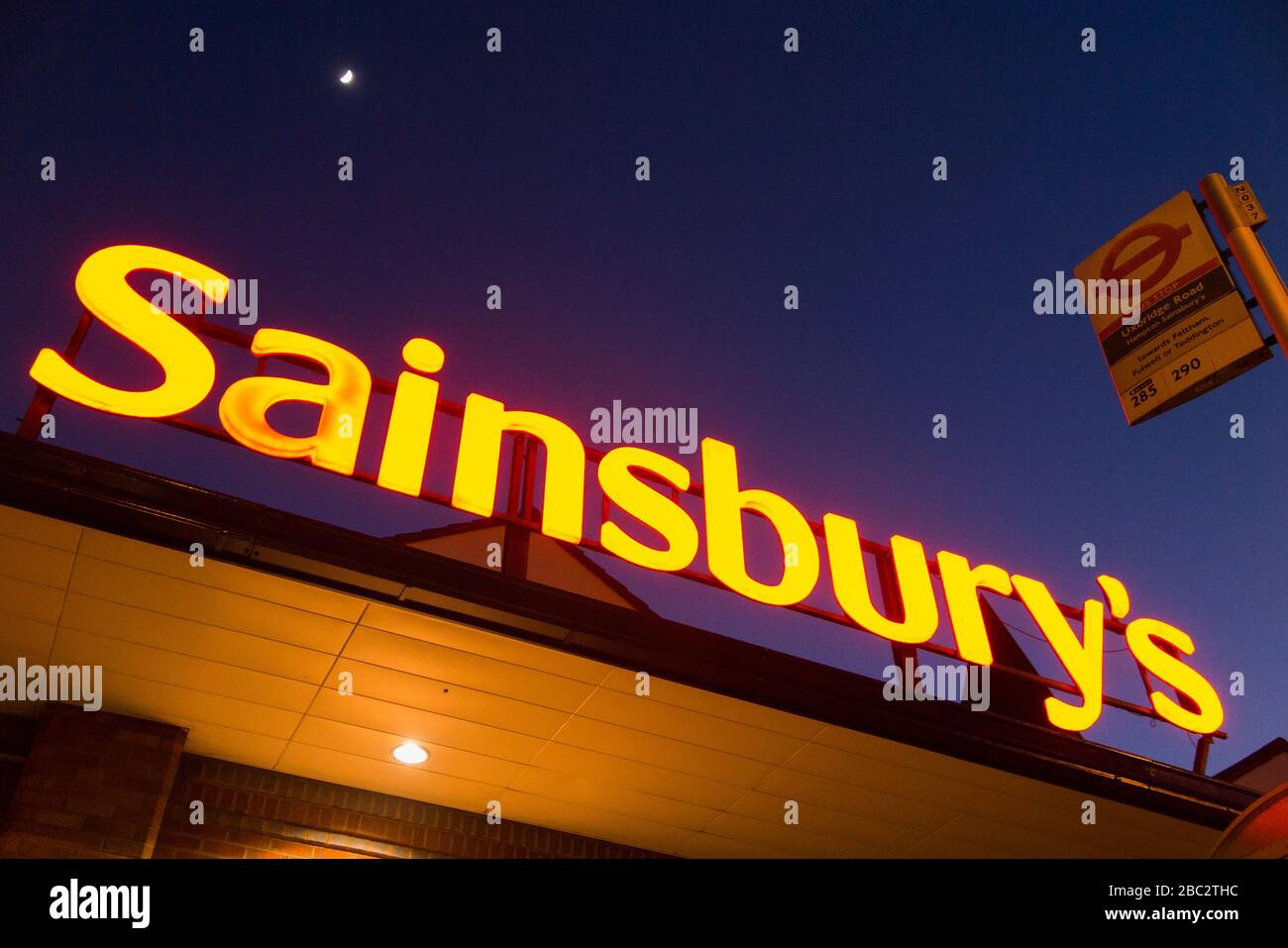 Sainsbury's supermarket shop sign at night / evening with clear blue ...