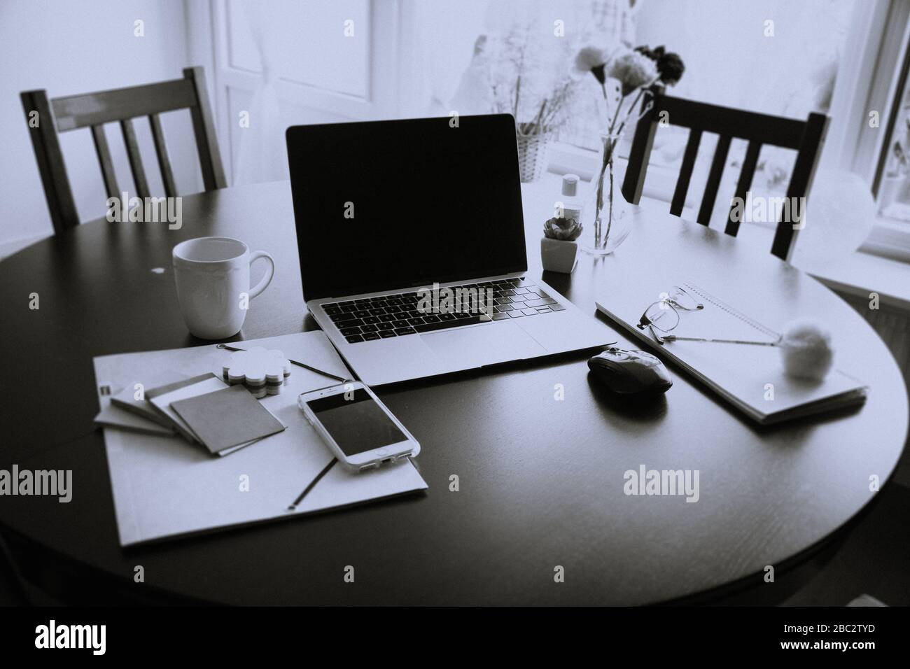Working from home concept with a laptop , coffee cup, mouse and notepad ...