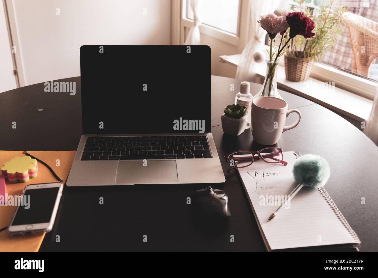 Working from home concept with a laptop , coffee cup, mouse and notepad ...