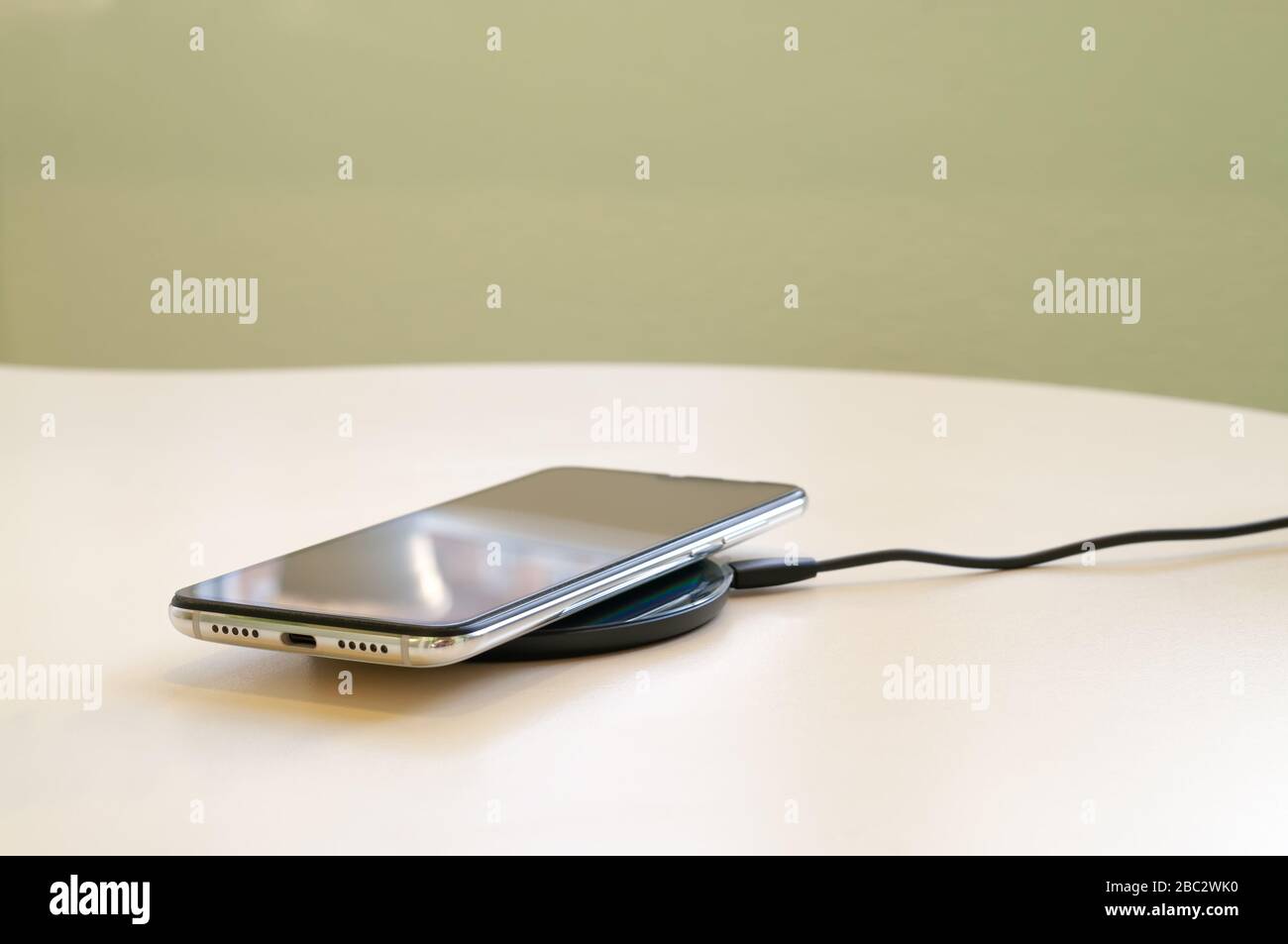 Smartphone wireless charging on induction charger. Wireless charger ...
