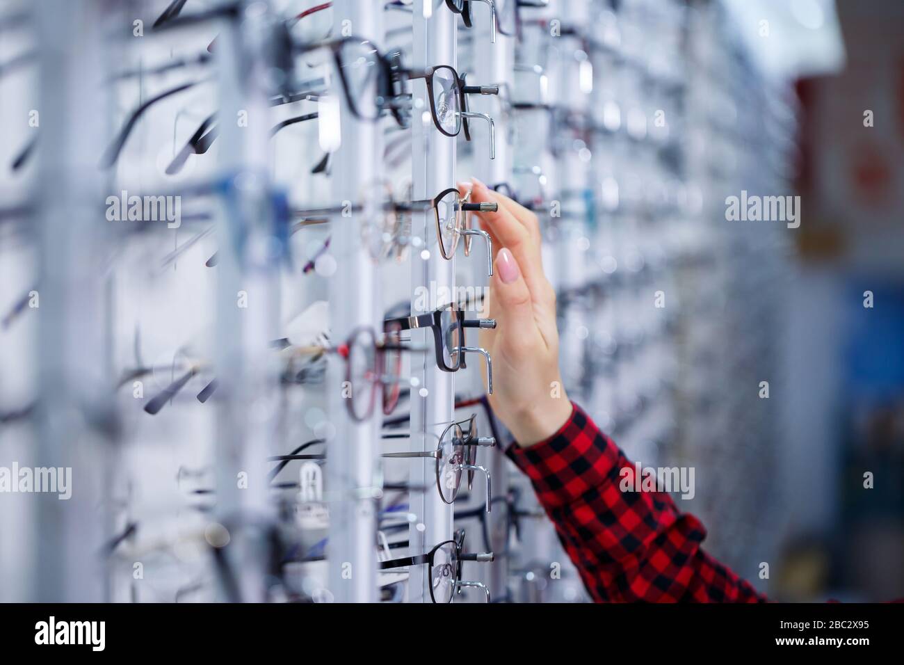 Row of glasses at an opticians. Eyeglasses shop. Stand with glasses in ...