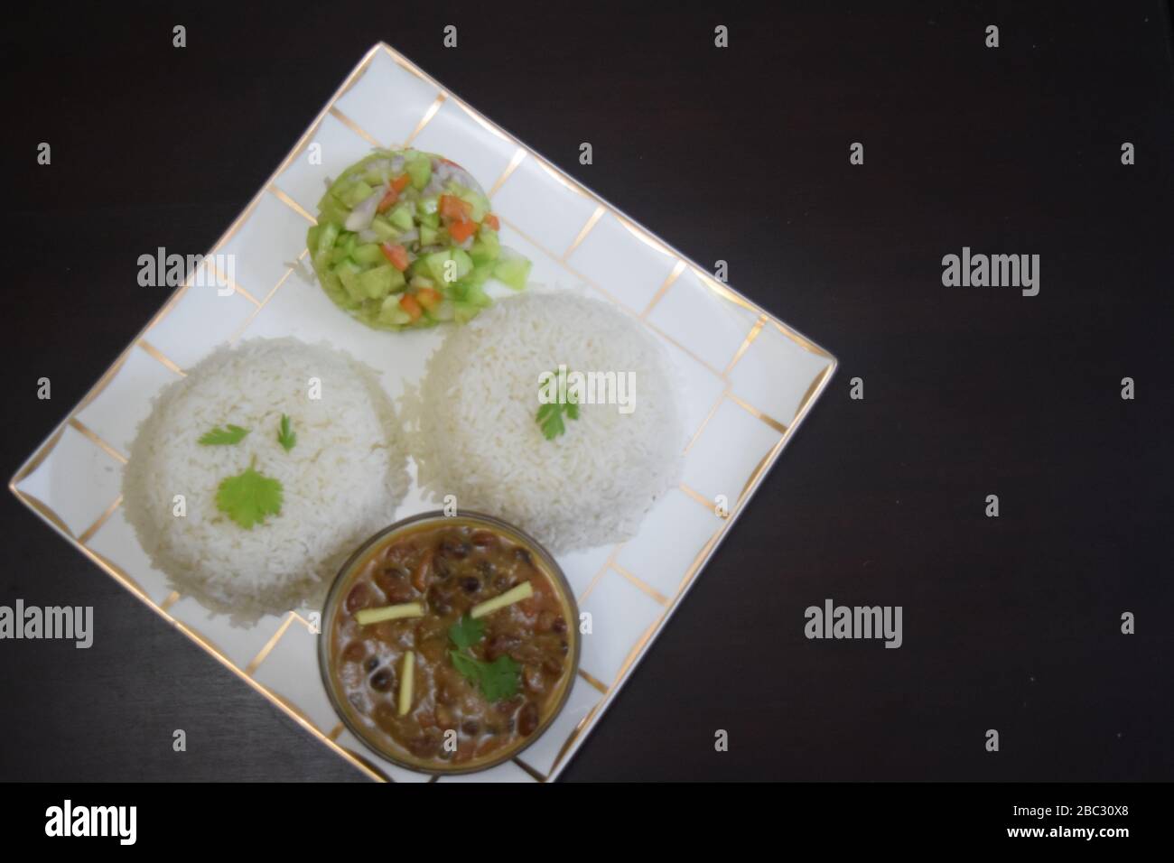 Two bowls of boil rice with cooked red beans and salad Stock Photo - Alamy