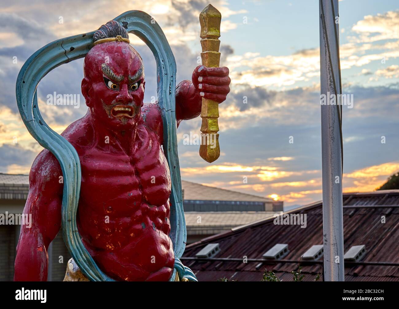 Sculpture of red angry religious guardian Stock Photo - Alamy