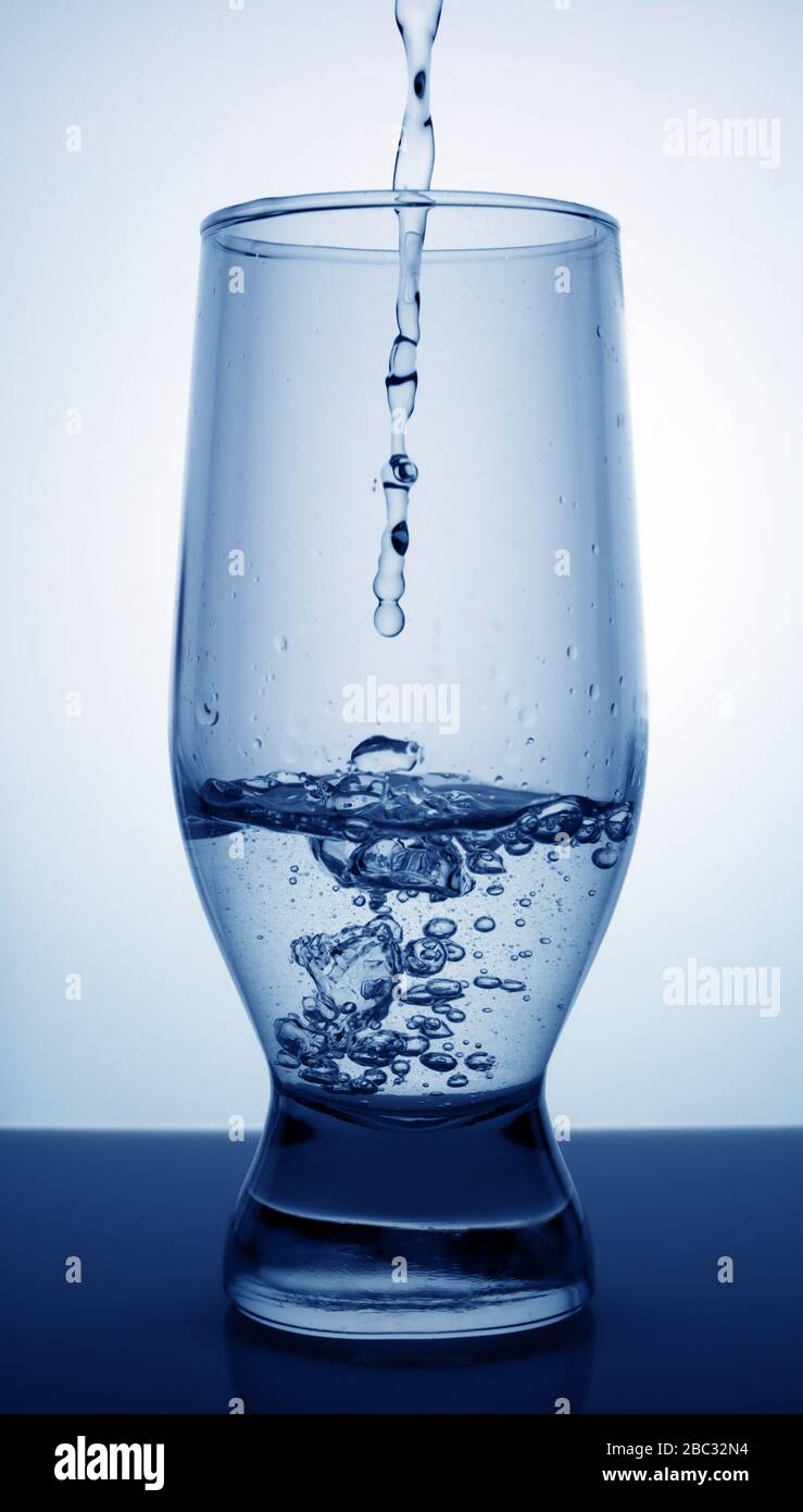 pure fresh water is poured into a glass Stock Photo - Alamy