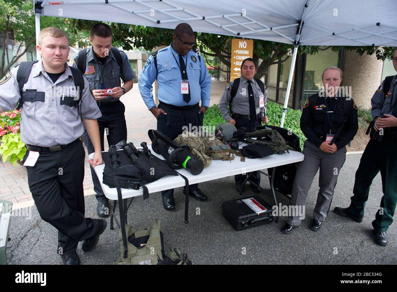 Group of law enforcement explorers standing around a table Stock Photo ...