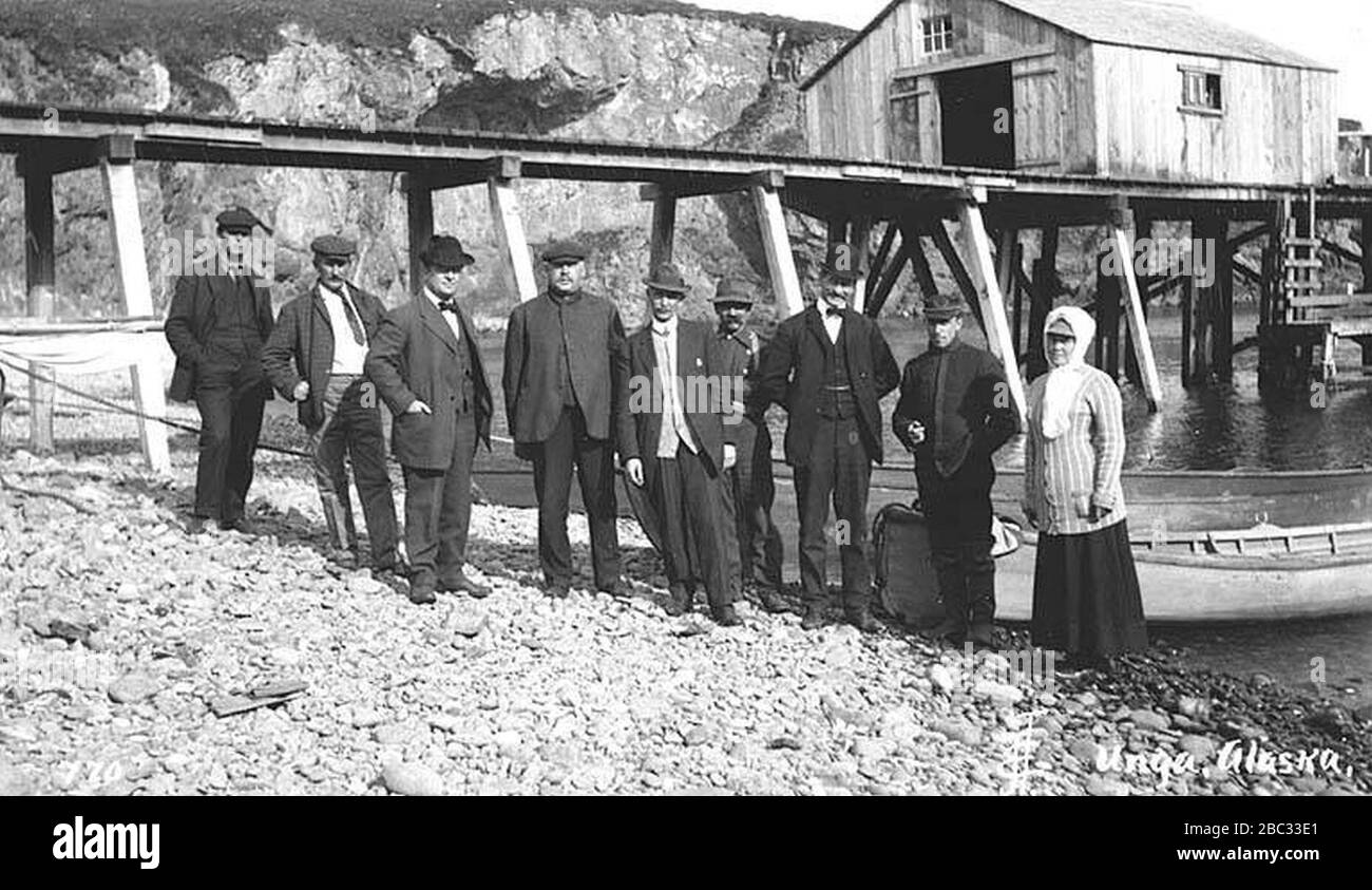 Group of people standing on shore near boat dock Squaw Harbor Unga ...