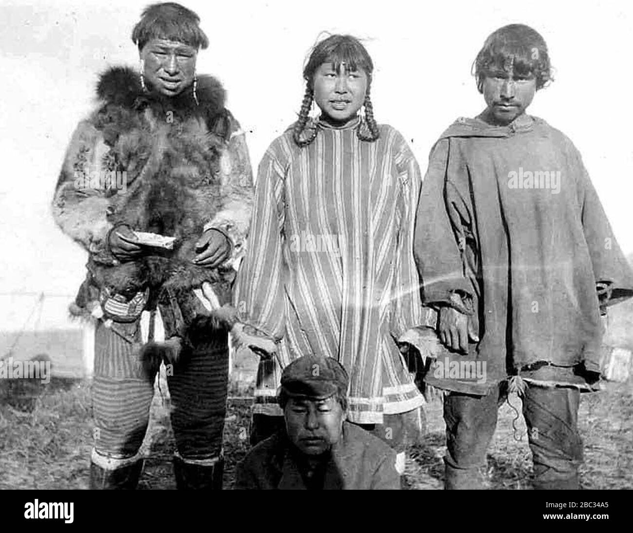 Group portrait of four Eskimos three men and a woman location unknown ...