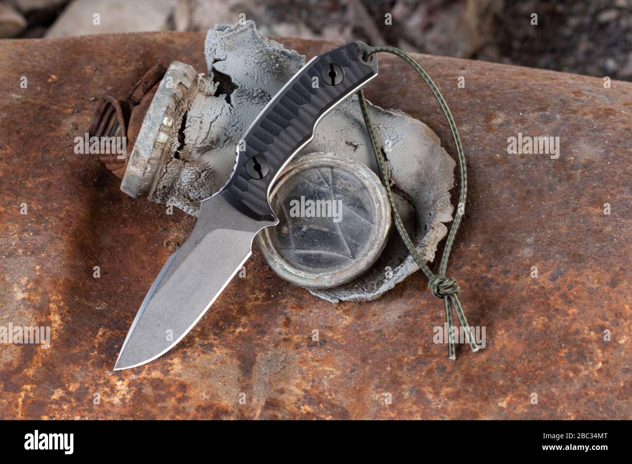 Old cracked gas mask and a sharp knife. Old rusty barrel. Top Stock ...