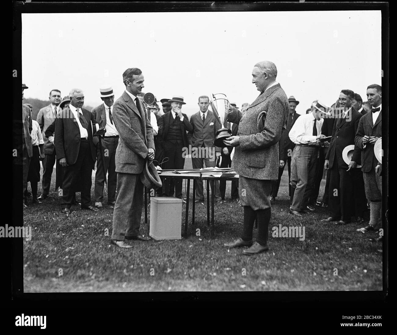 Group with Warren G. Harding holding trophy Stock Photo - Alamy