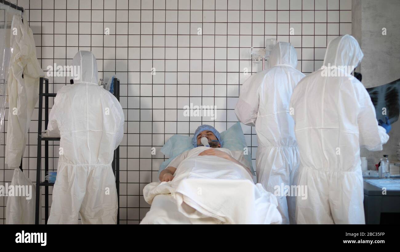 Doctors in Hazmat Sterile Suit around the patient in a hospital Stock ...