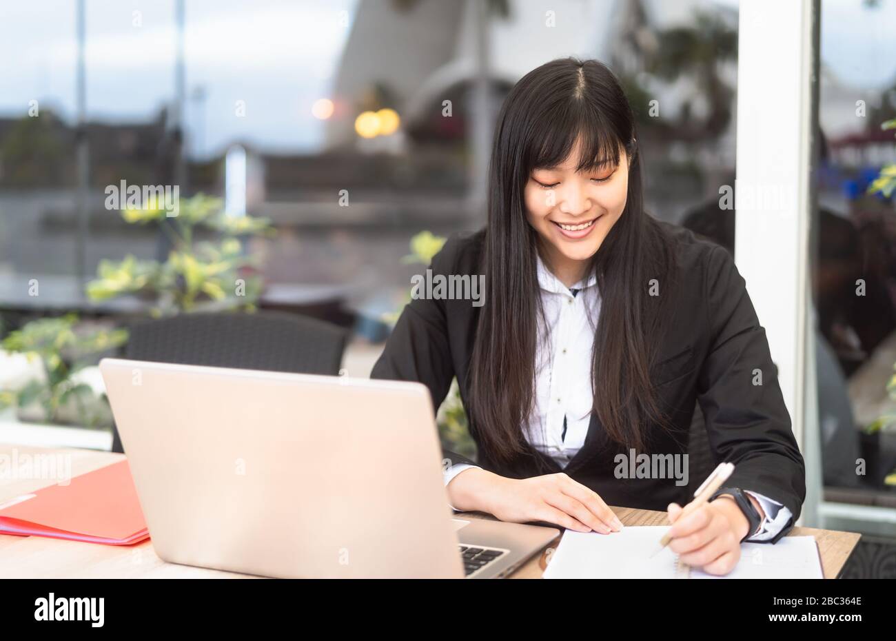 Business Asian woman working on computer outdoor - Happy Chinese girl ...