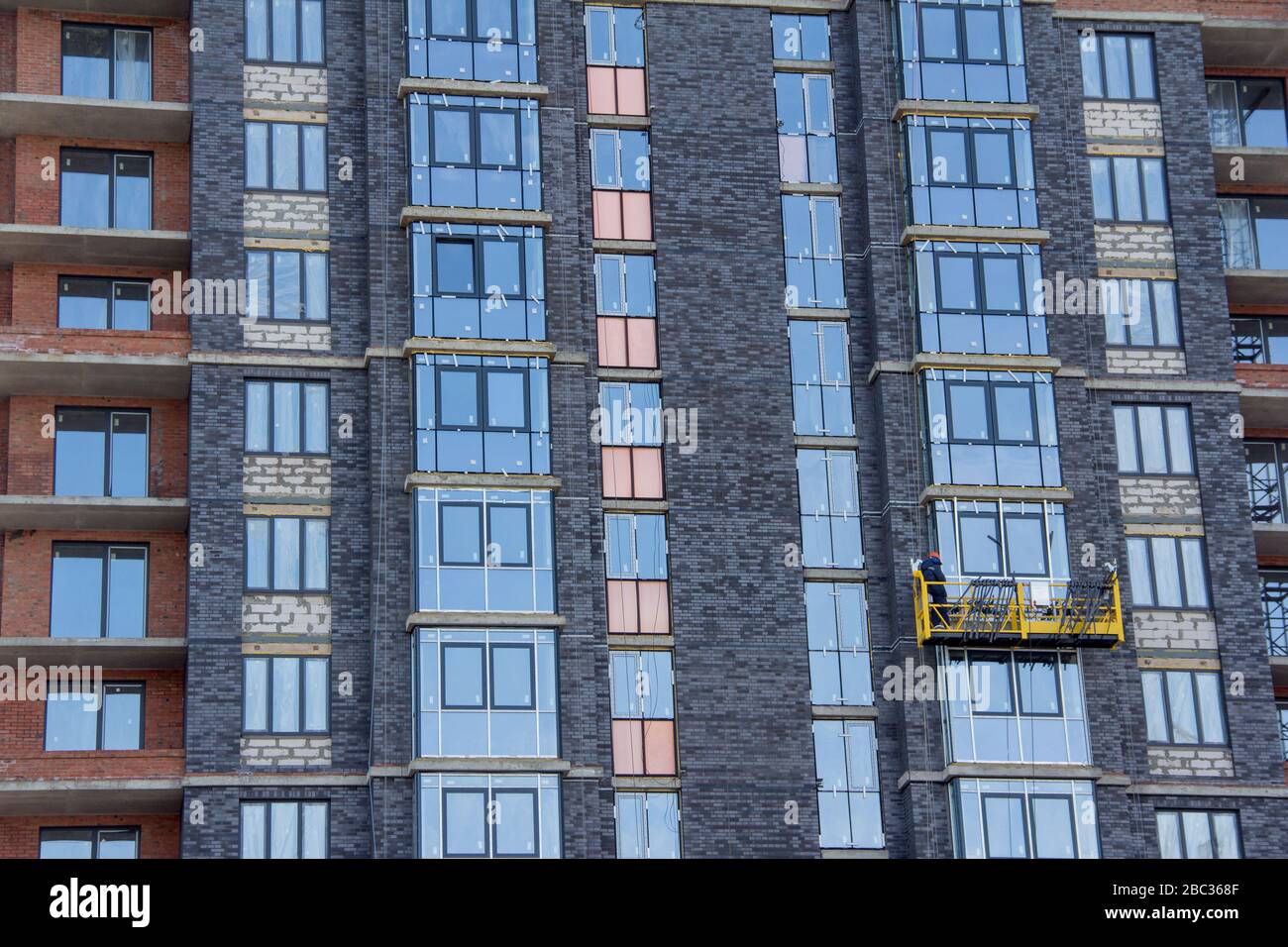Construction cradle on the background facade of the building under ...