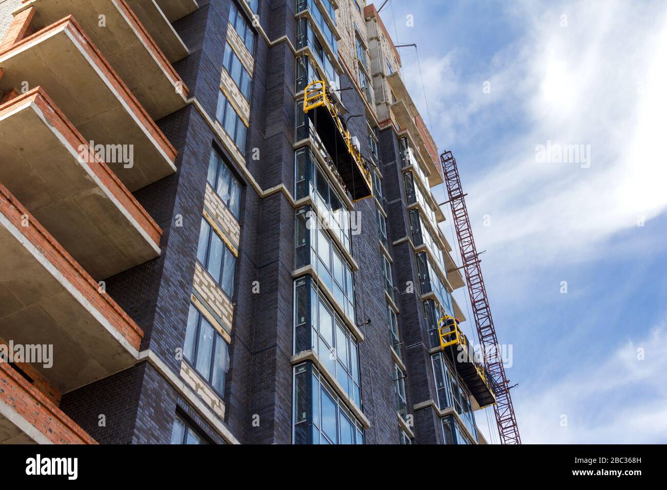 Construction cradle on the background facade of the building under ...