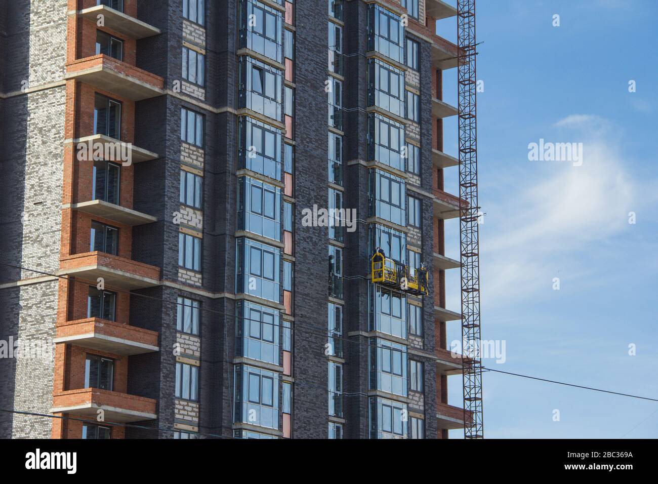 Construction cradle on the background facade of the building under ...