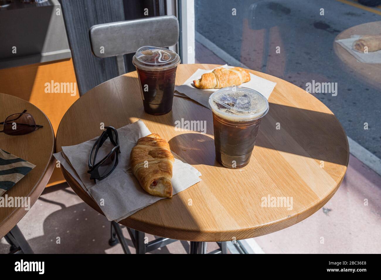 Beautiful close up view of round table with two coffee cups and pies ...