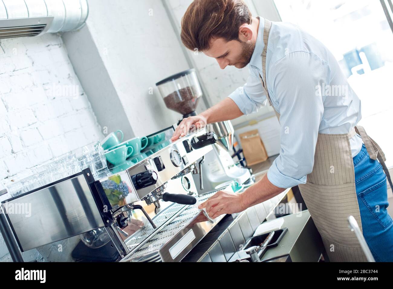 Young pensive male barista hi-res stock photography and images - Alamy